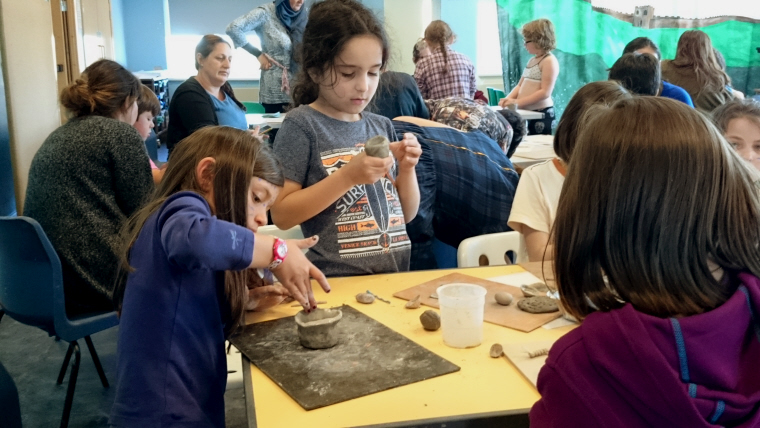 Kids of the wild learning to make push pots with clay