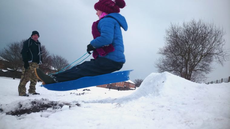 Getting some air – Kids of the Wild enjoying snow jumps on a sledge